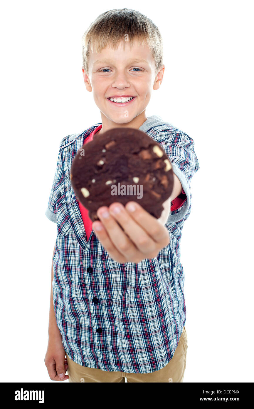 Portrait of a happy little young boy holding choco chip cookie close to ...