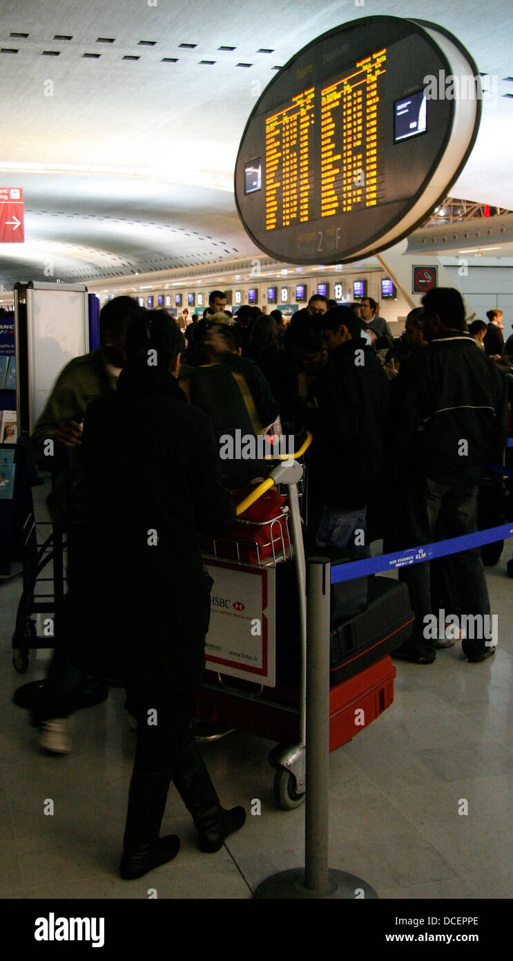 Air travelers queuing to check-in at busy airport terminal of Roissy ...