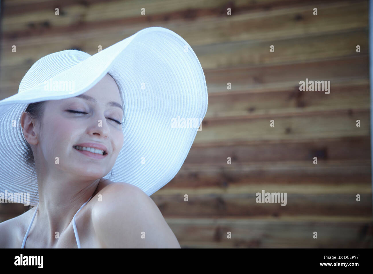 a lady in bikini wearing beach hat Stock Photo - Alamy