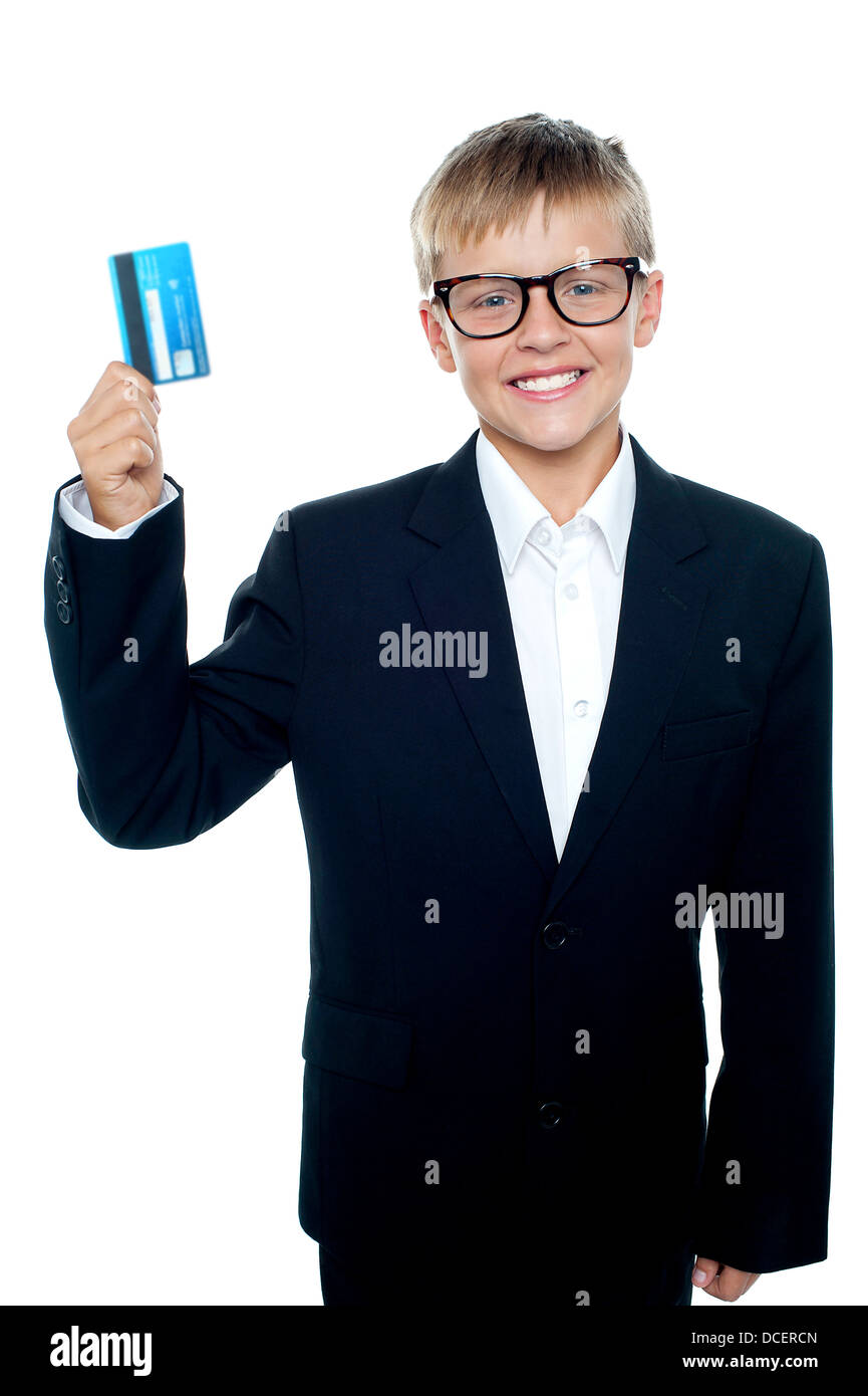 Smartly dressed young boy standing in front of the camera showing off ...
