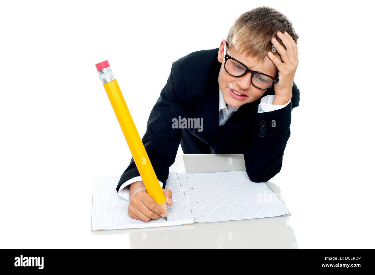 Stressed out boy mid way through his test holding his head in ...