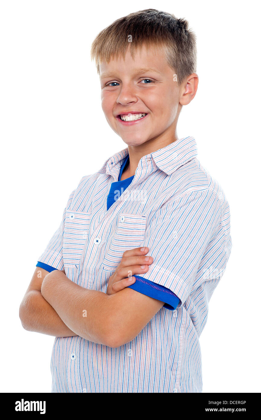 Cheerful handsome young boy posing confidently with his hands crossed ...