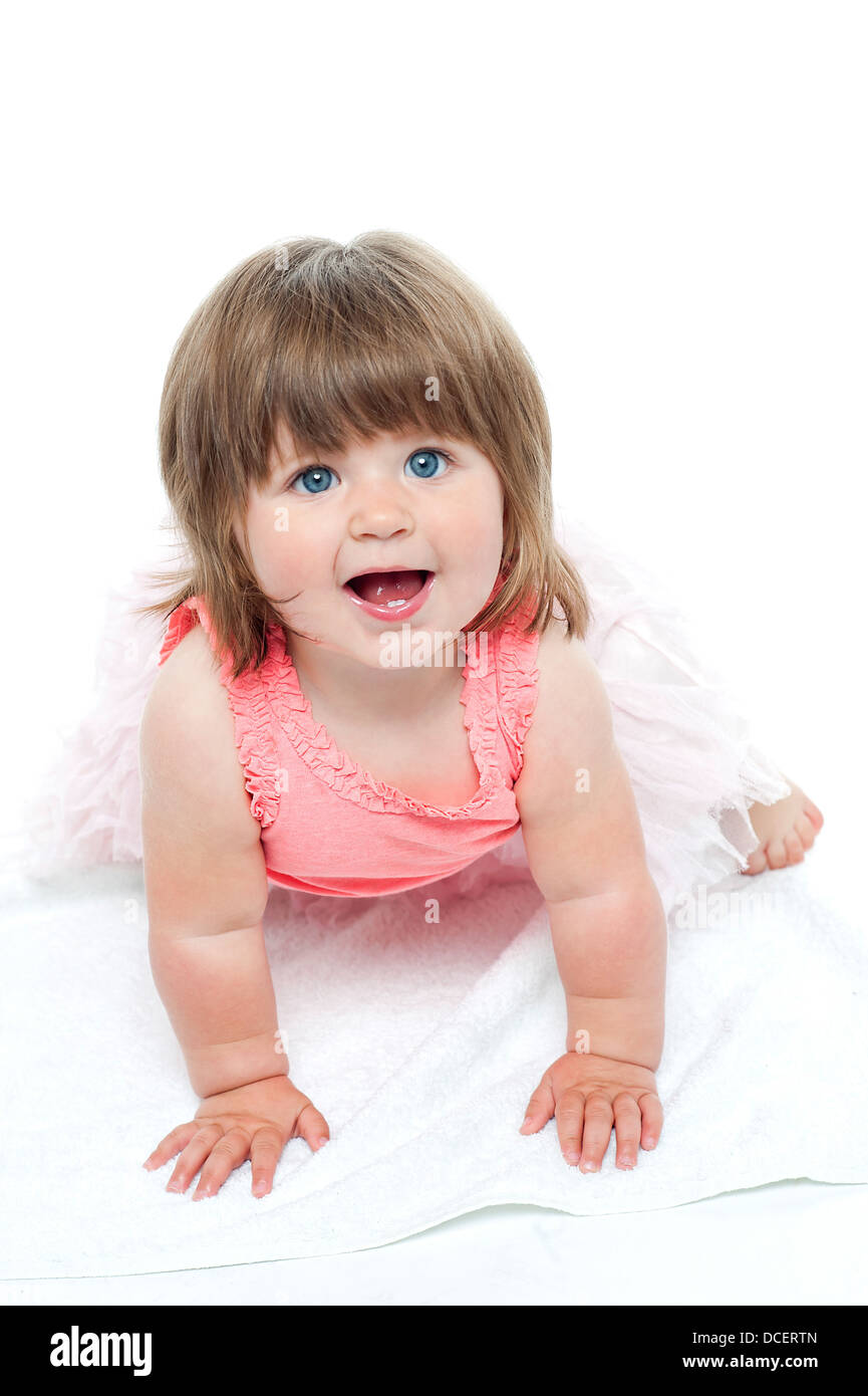 A cute little baby girl is staring up. Crawling, studio shot Stock ...