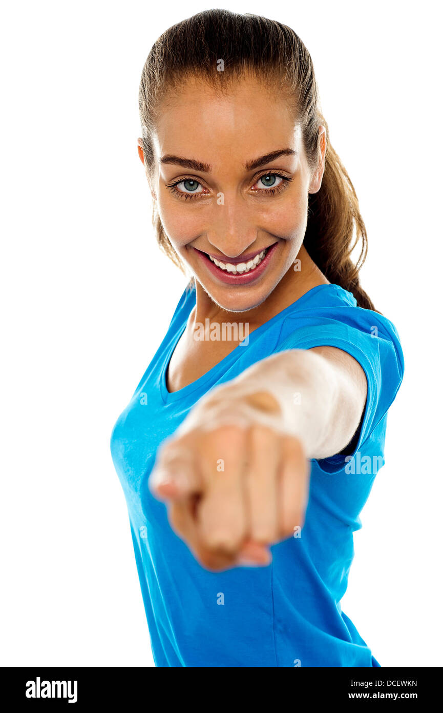 Stylish lady pointing her finger towards the camera. Studio white ...