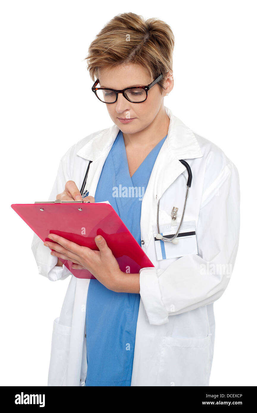 Medical practitioner writing prescription and preparing patients report ...