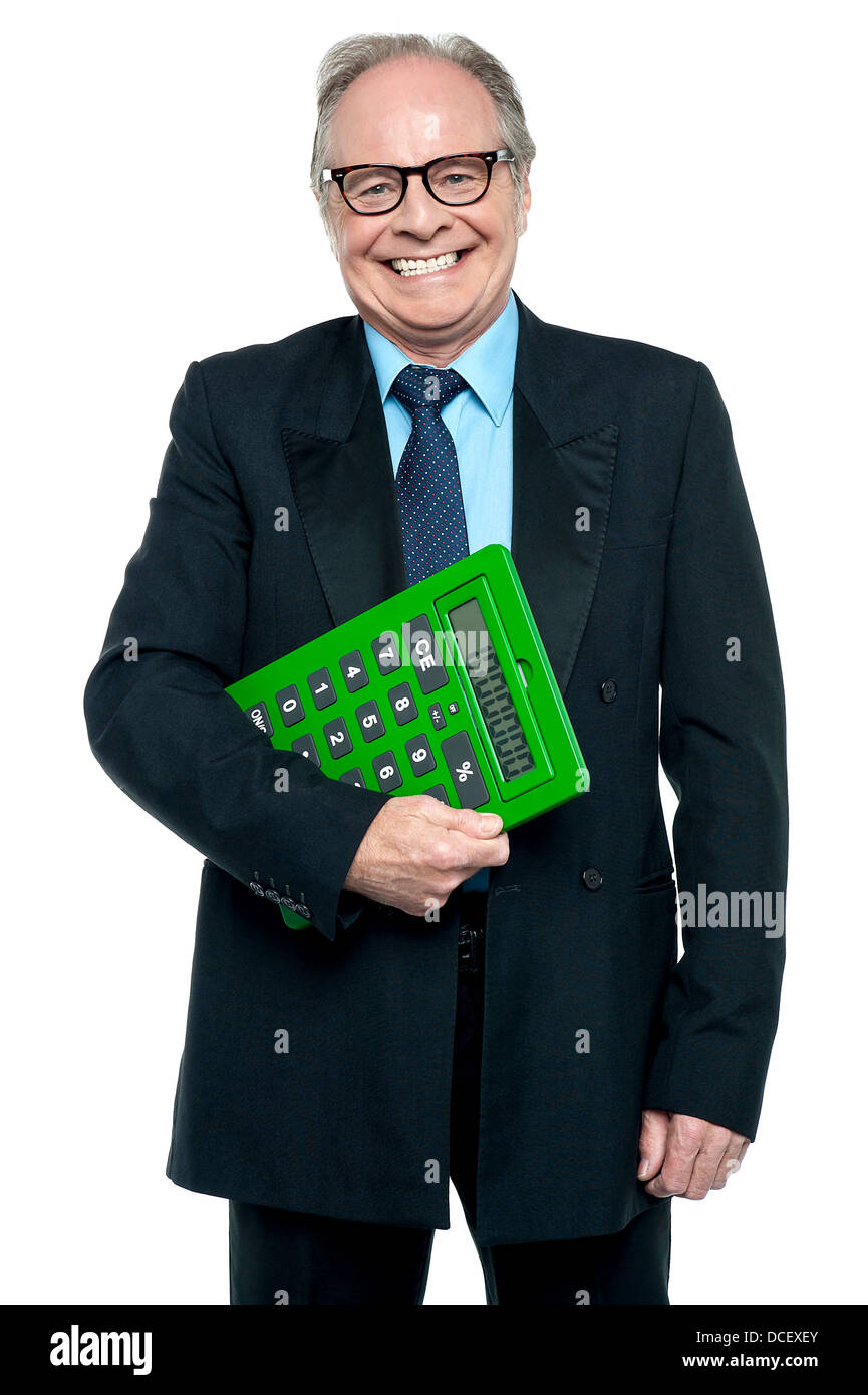 Successful senior male manager with a big green calculator in his hand ...