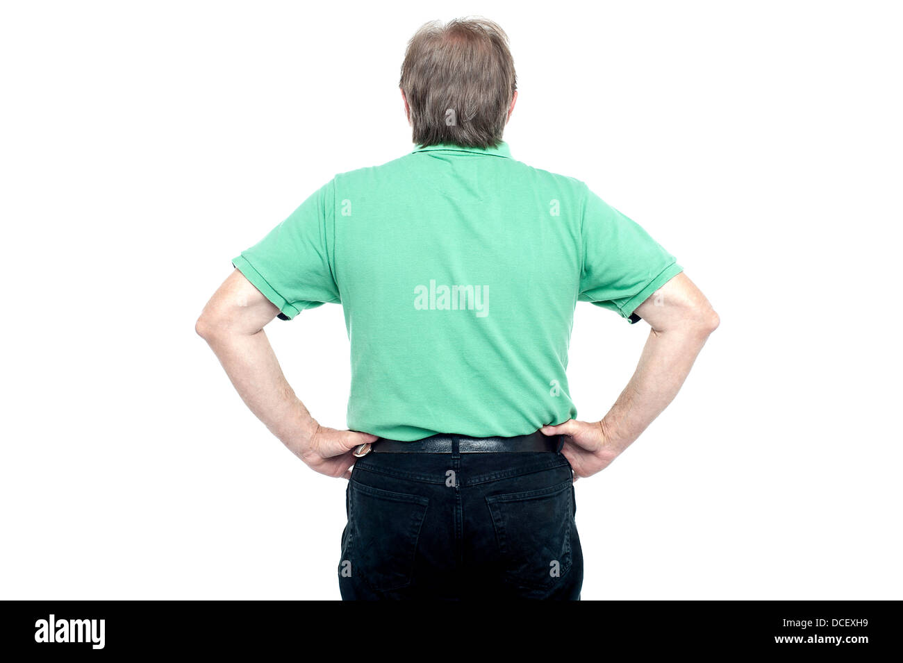 Back pose of elderly guy with hands on his waist. Facing opposite side ...