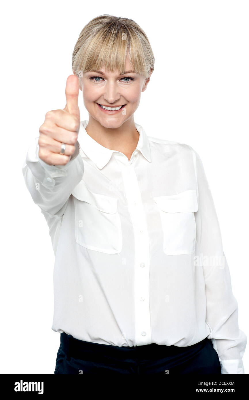 Successful businesswoman showing thumbs up sign to the camera, feeling ...