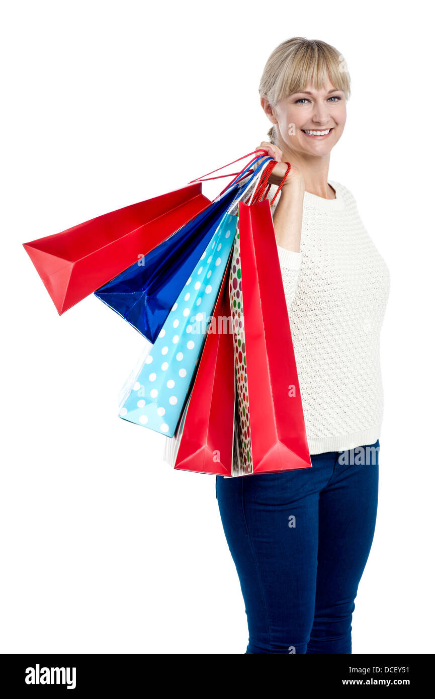 Stylish woman with colorful shopping bags slung over her shoulder Stock ...