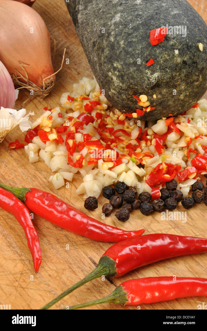 some fresh crushed organic spices and pestle Stock Photo - Alamy