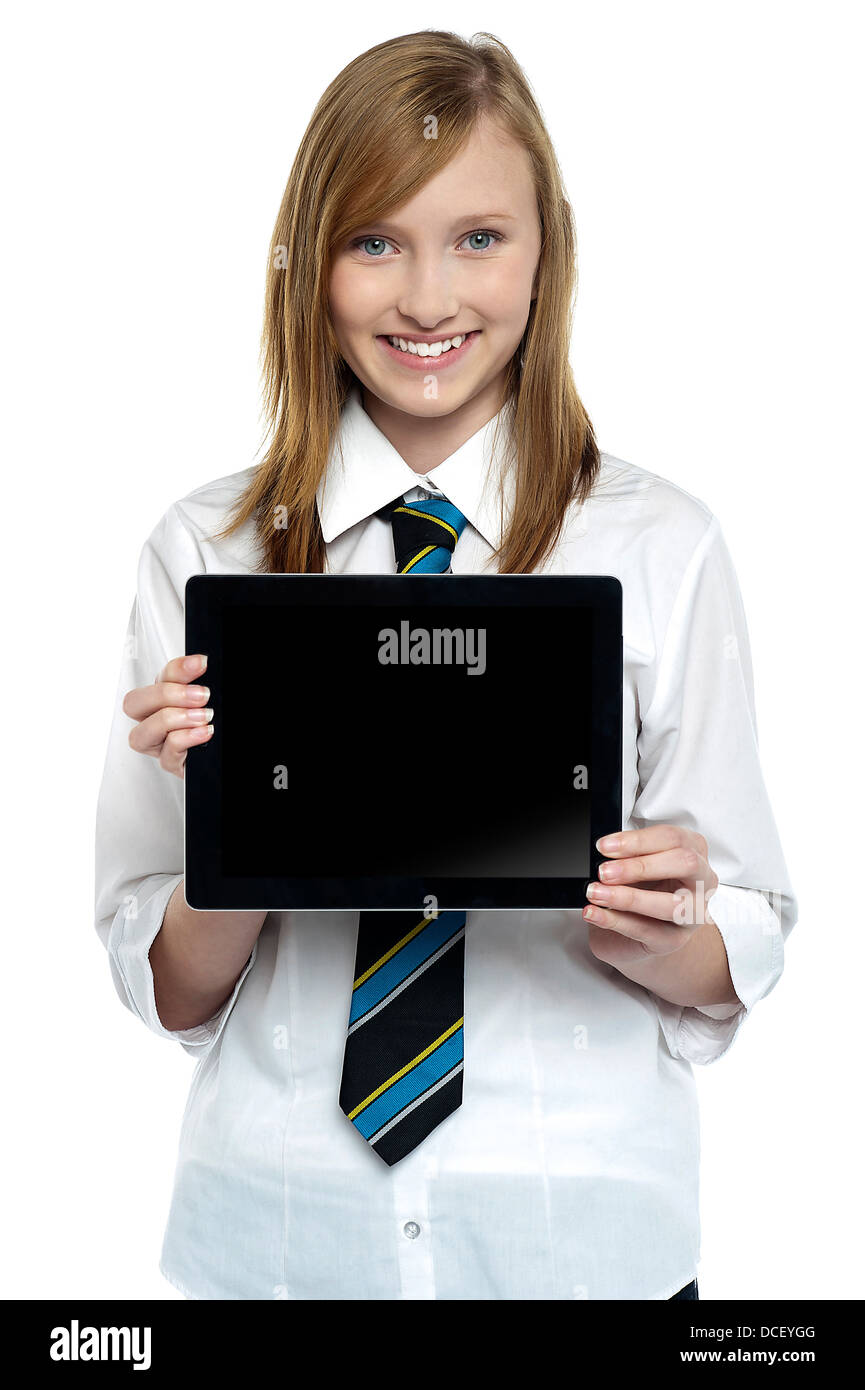 Pretty college girl displaying newly launched tablet device to the ...
