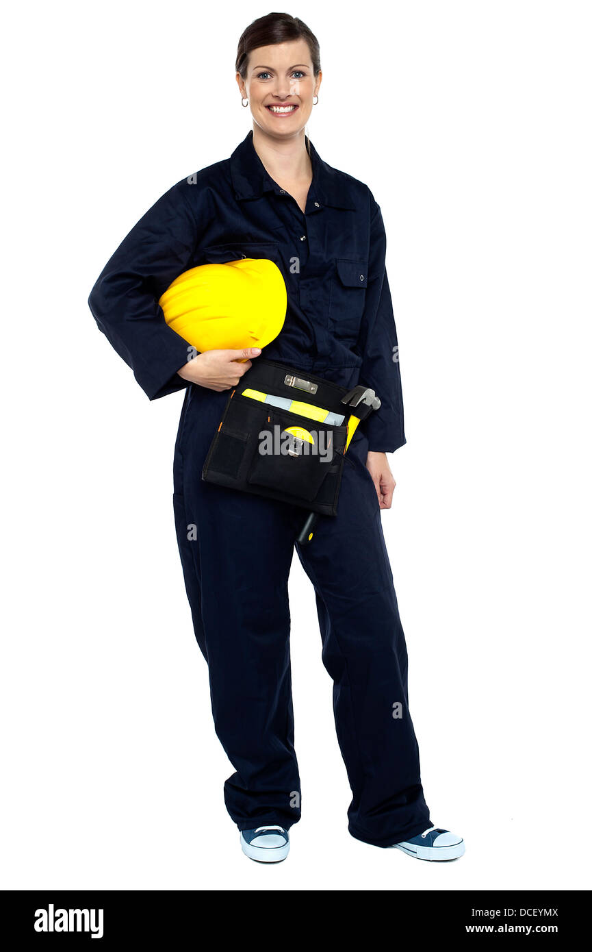 Full length studio shot of a relaxed construction worker with yellow ...