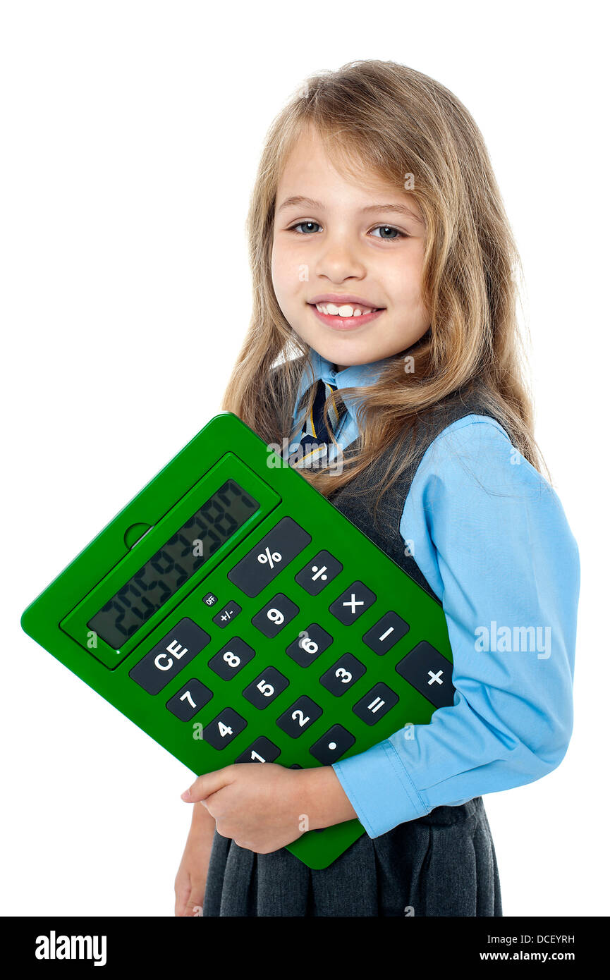 Lovely young school girl holding calculator and facing camera Stock ...