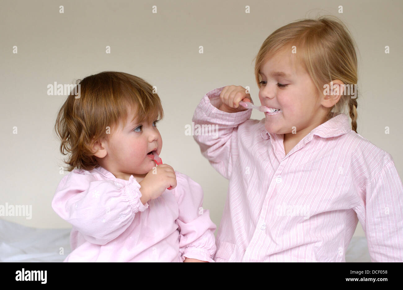 Two girls brushing their teeth Stock Photo - Alamy