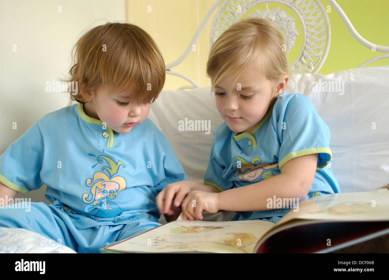 Two children with a book hi-res stock photography and images - Alamy