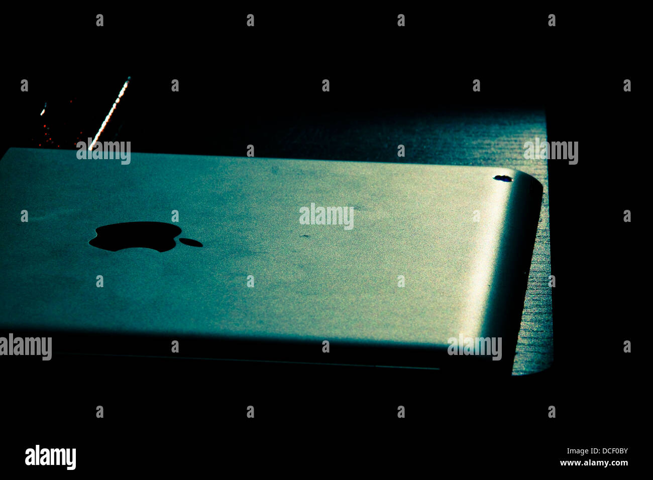 iPad lying face down on table sidelit Stock Photo - Alamy