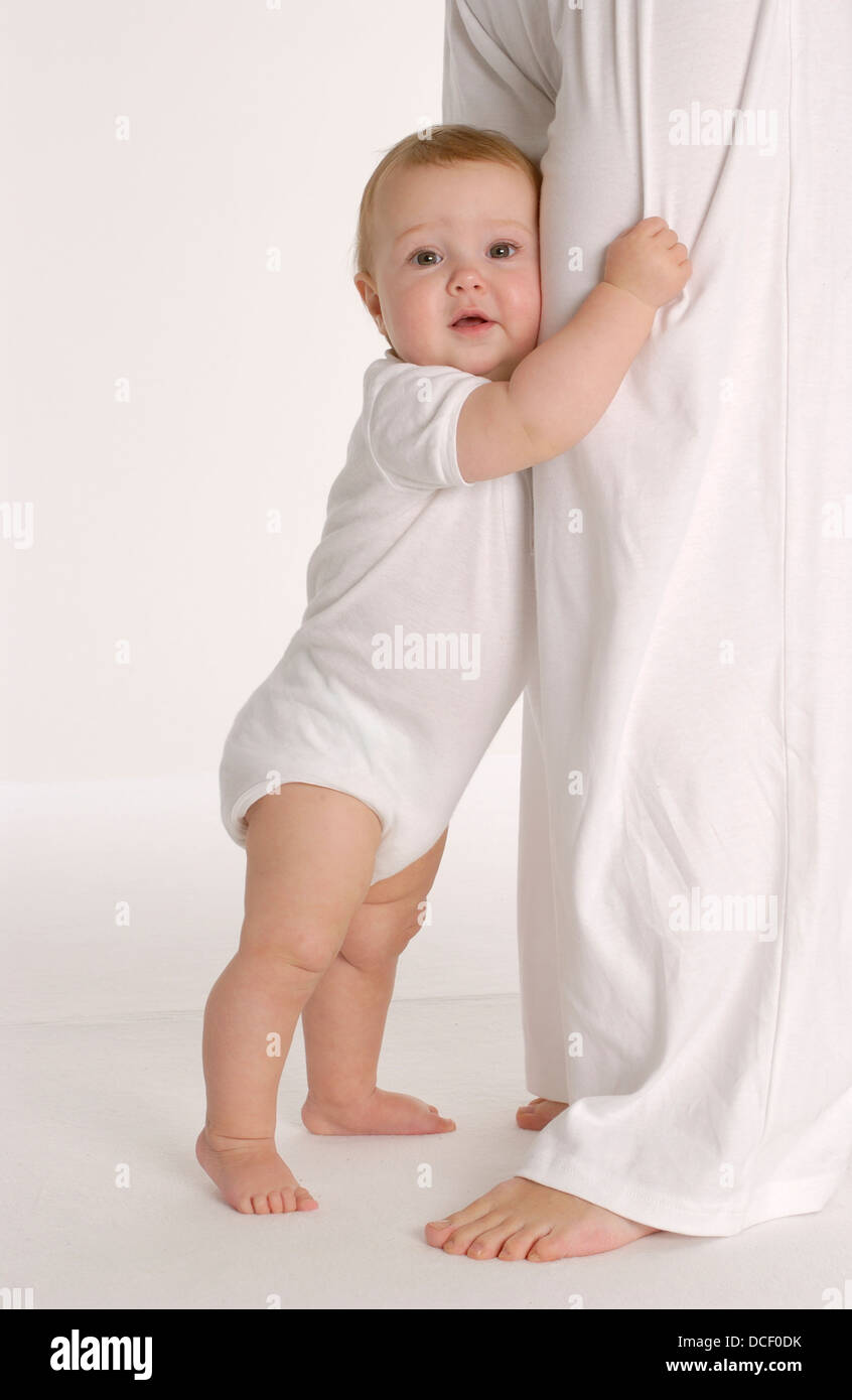 Little baby girl is trying to stand Stock Photo - Alamy