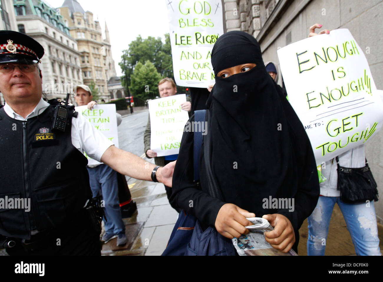 Right wing protesters hold banners when Rebekah Dawson arrives to The ...