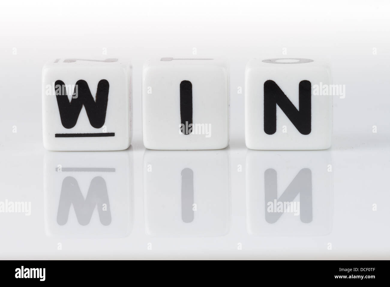 Win spelled in dice letters reflected on white isolated background ...