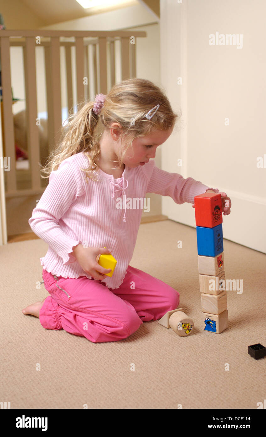Little girl playing with blocks Stock Photo - Alamy