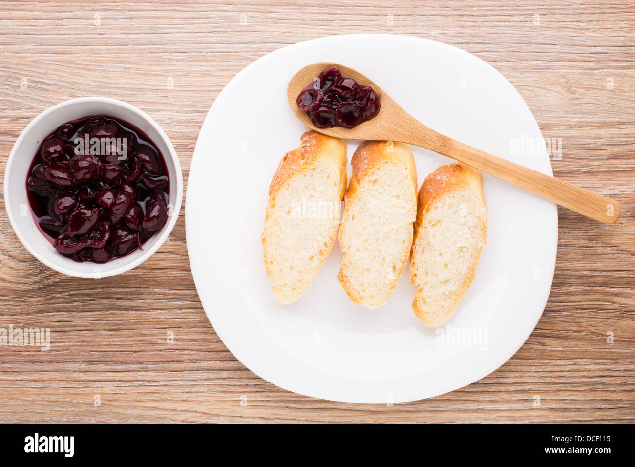 Slices of baguette with cherry jam Stock Photo - Alamy