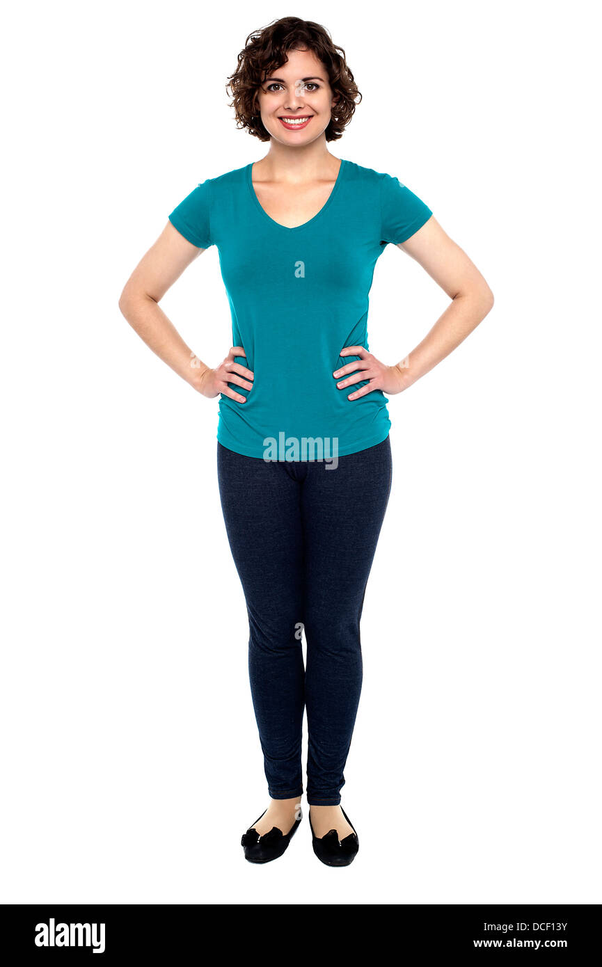 Full length portrait of a gorgeous young woman standing with hands on ...