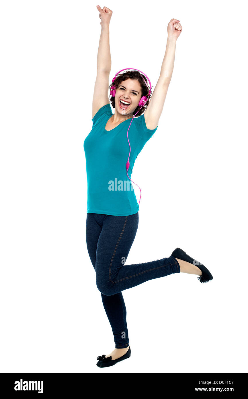 Charming young female dancing to the beat, full length over white Stock ...