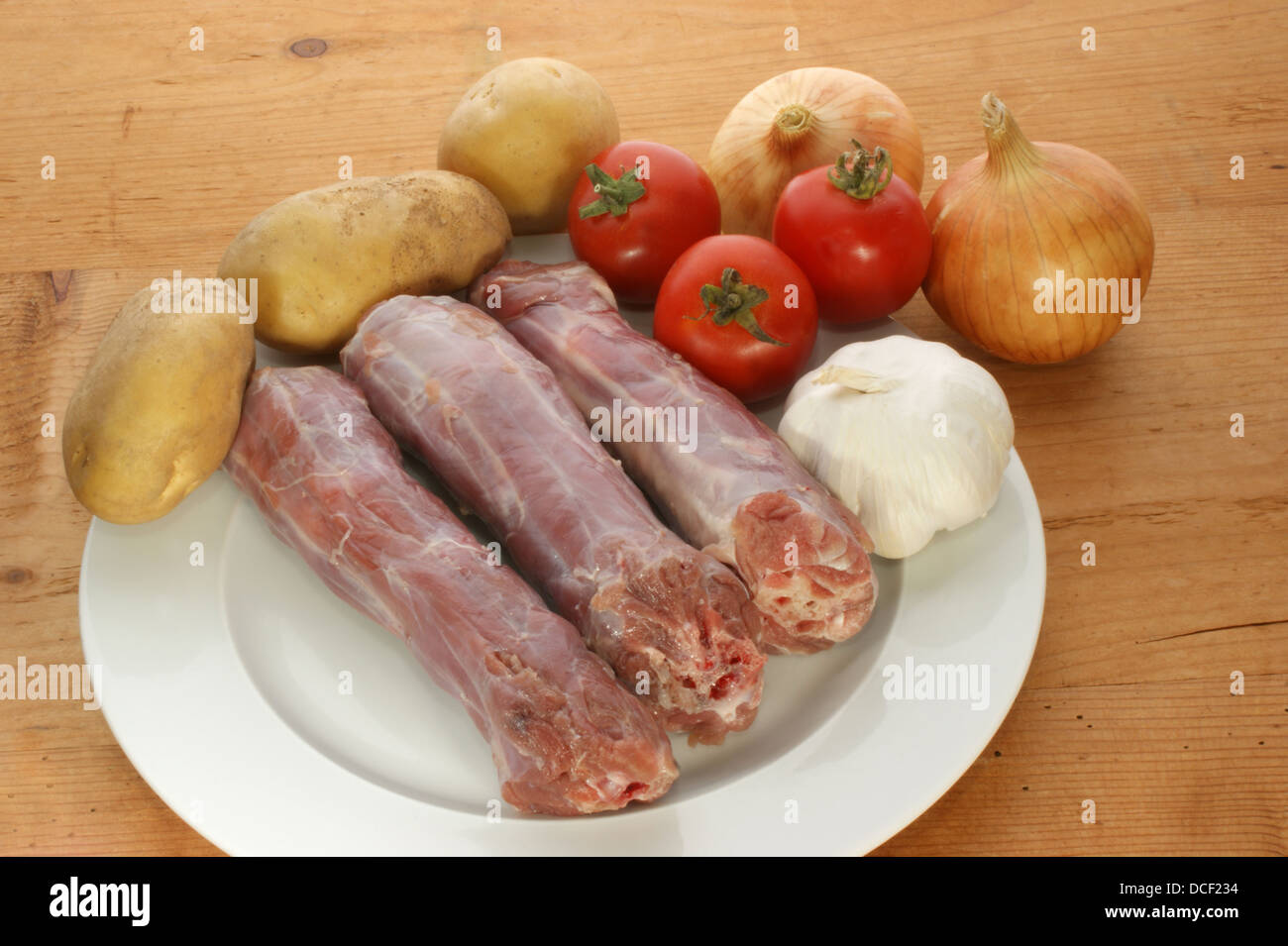 raw turkey neck with vegetables on a plate Stock Photo - Alamy