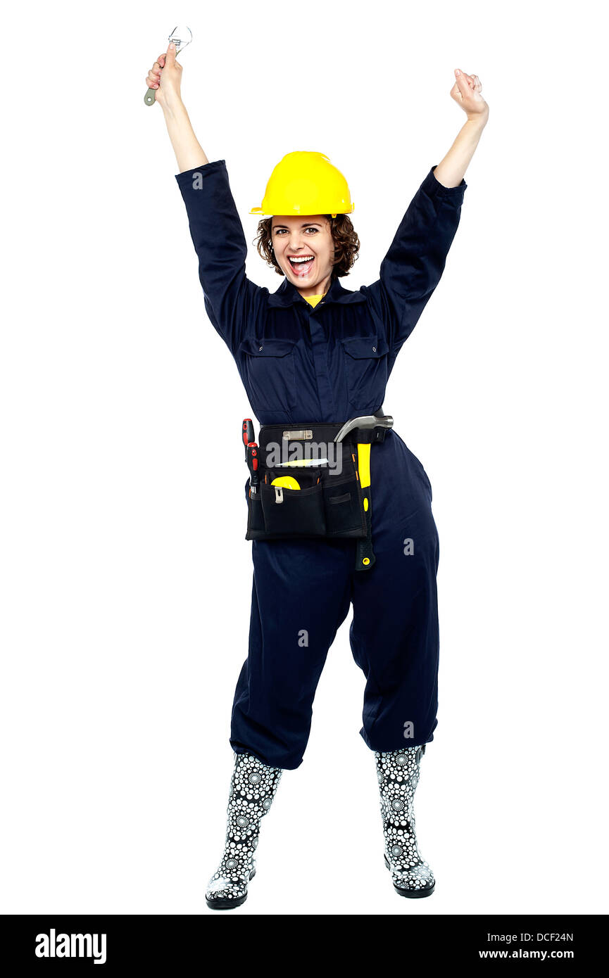 Jubilant young craftswoman throwing her arms up in excitement Stock ...