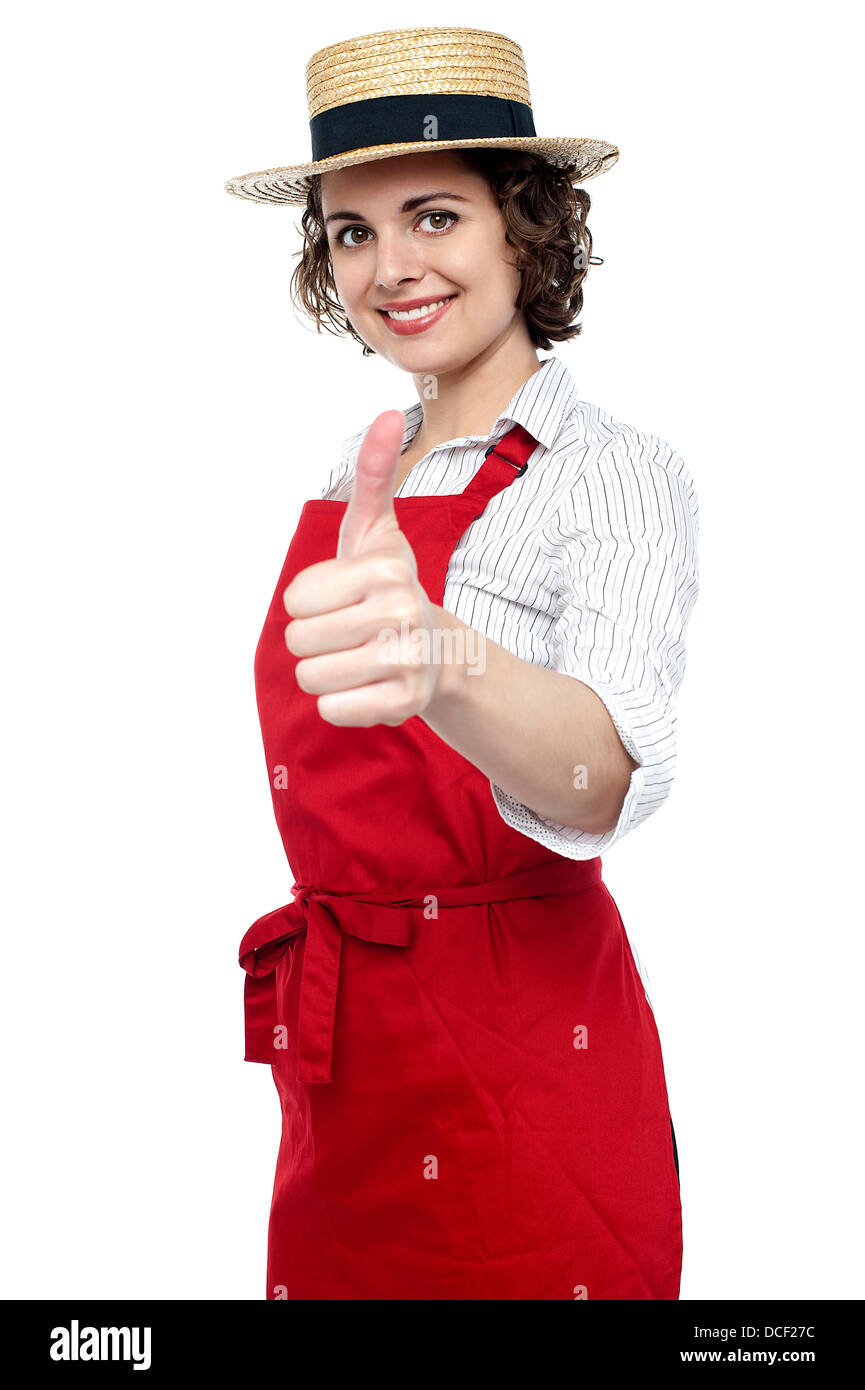 Pretty baker woman in red apron showing thumbs up gesture Stock Photo ...