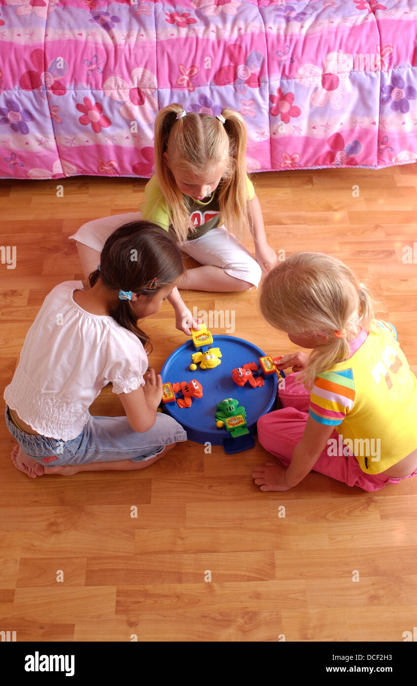 Three little girls playing a game Stock Photo - Alamy