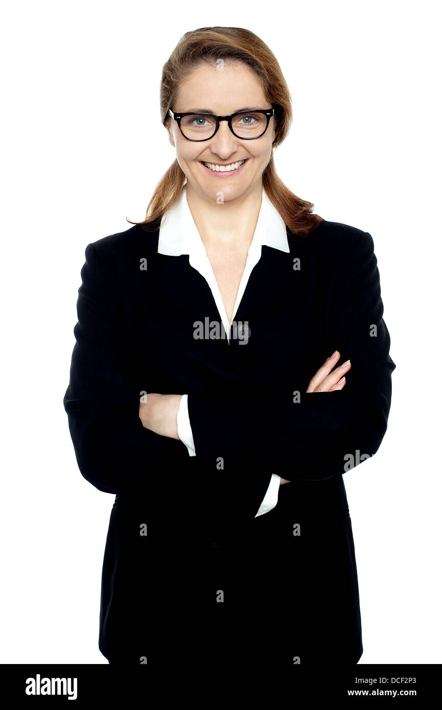 Bespectacled businesswoman with her arms crossed smiling at the camera ...