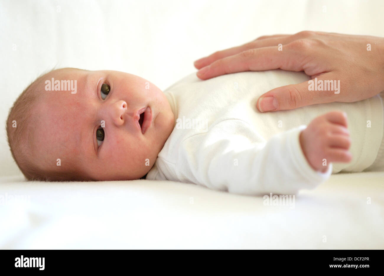 Baby girl looking up to his parent Stock Photo - Alamy