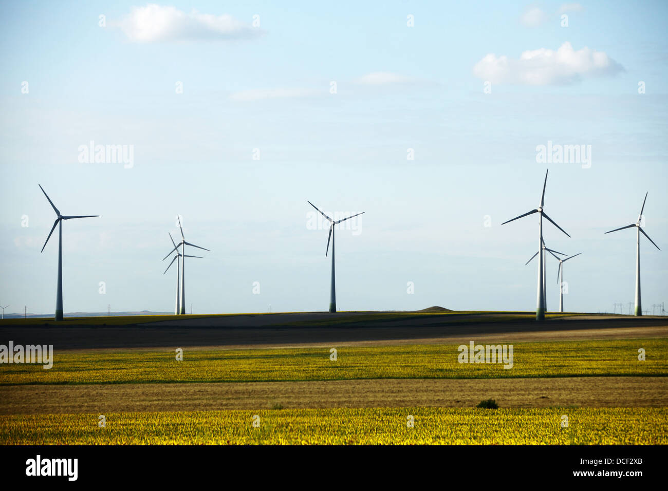 Some wind mills on a meadow, under a cloudy sky Stock Photo - Alamy