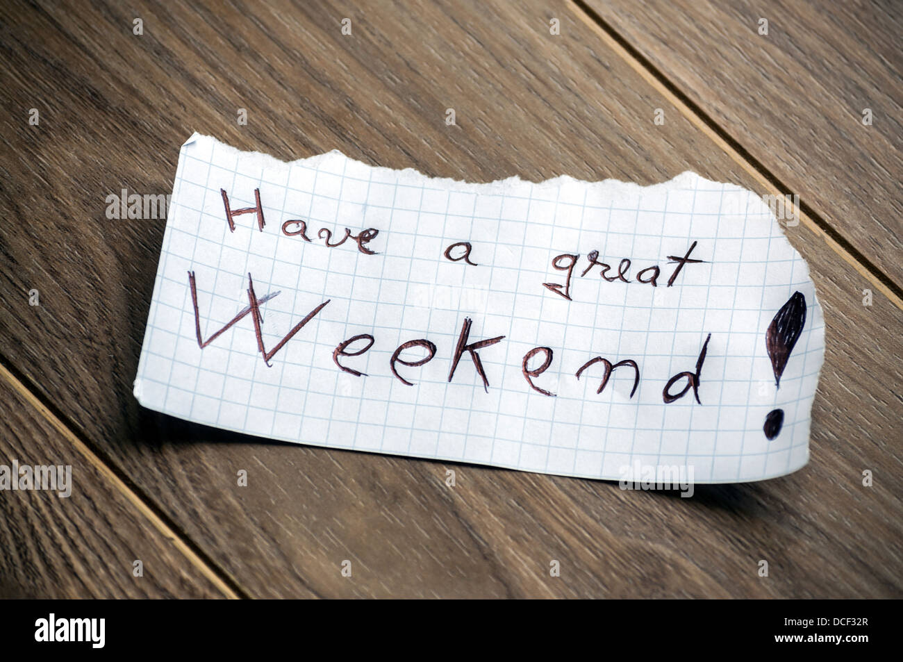 Have a great Weekend - Hand writing text on a piece of paper on wood ...