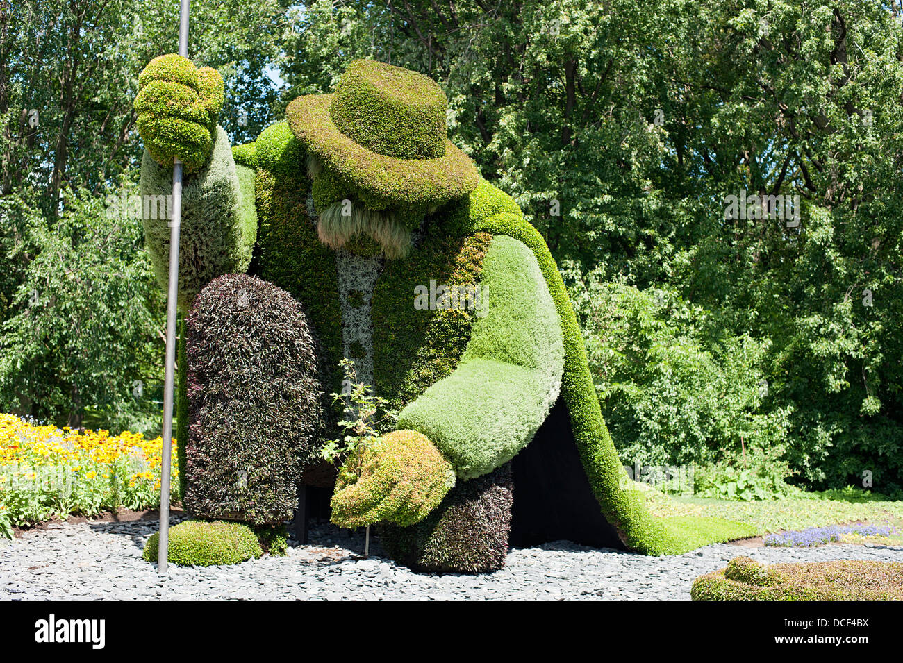 The Mosaiculture sculpture of a shepherd planting a young oak Stock ...