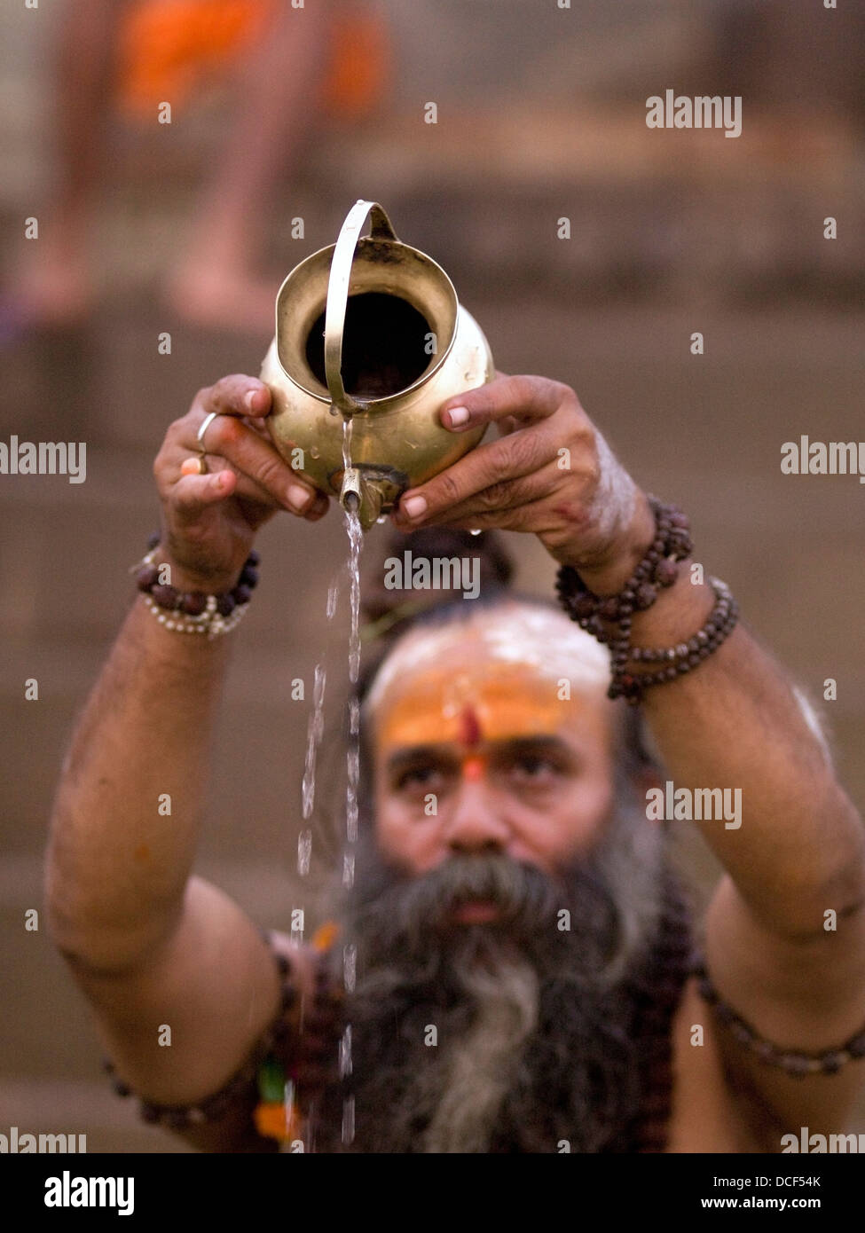 A Sadhu Pouring Libations Into The Ganges; Ganges River,Varanasi,India ...