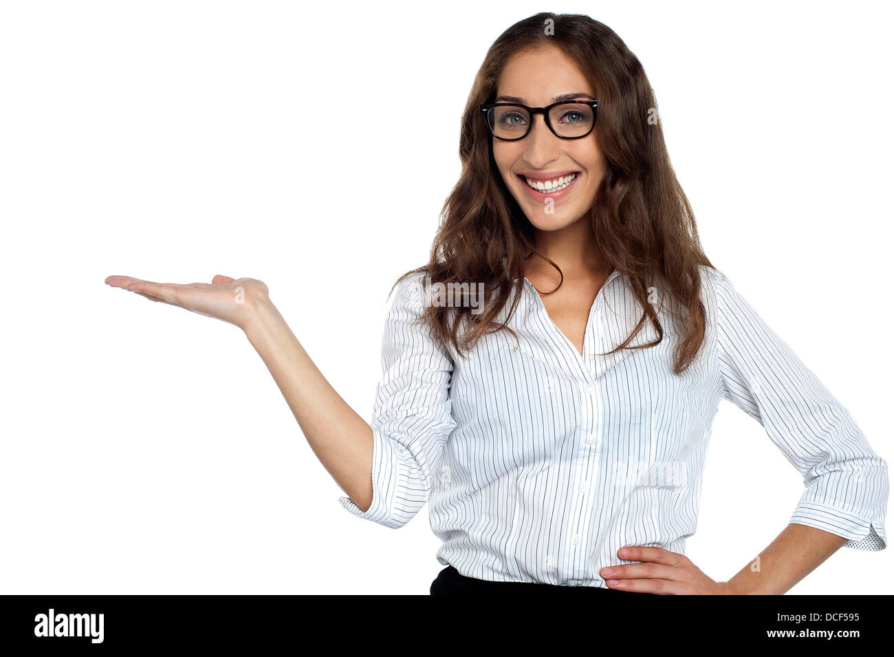 Joyous woman in spectacles posing with open palm, copy space concept ...