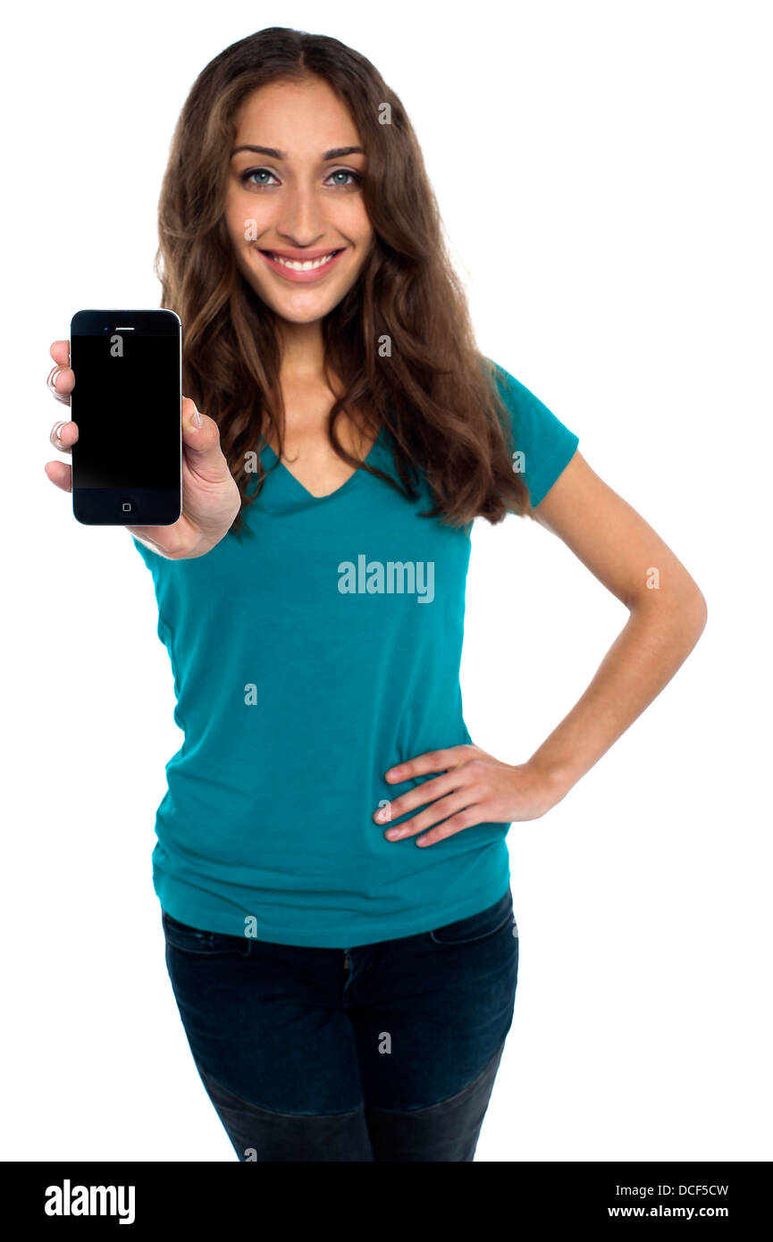 Charming young model displaying a newly launched mobile to you Stock ...