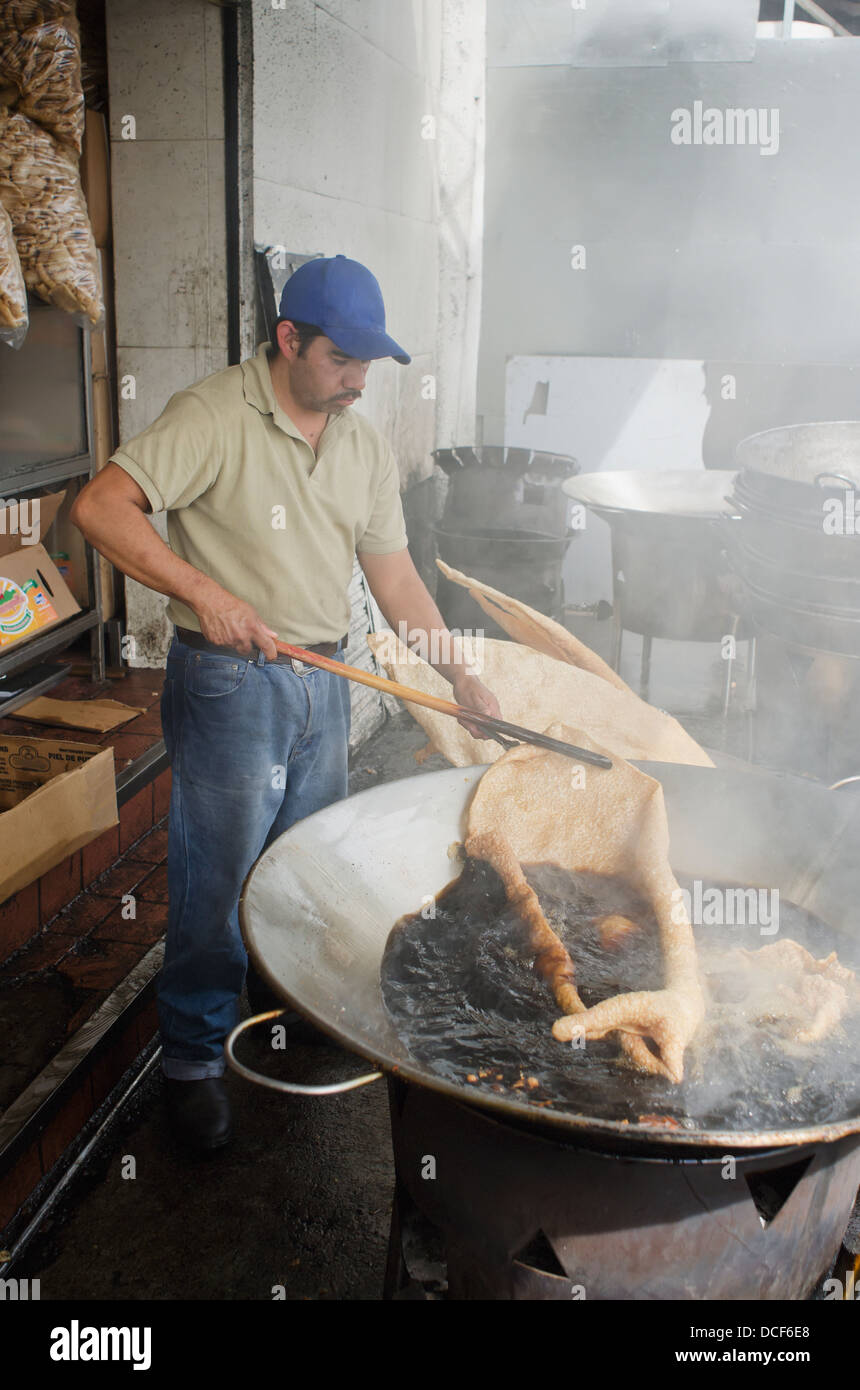 Man cooking chicharron, deep fried pig skin; Aguascalientes, Mexico ...
