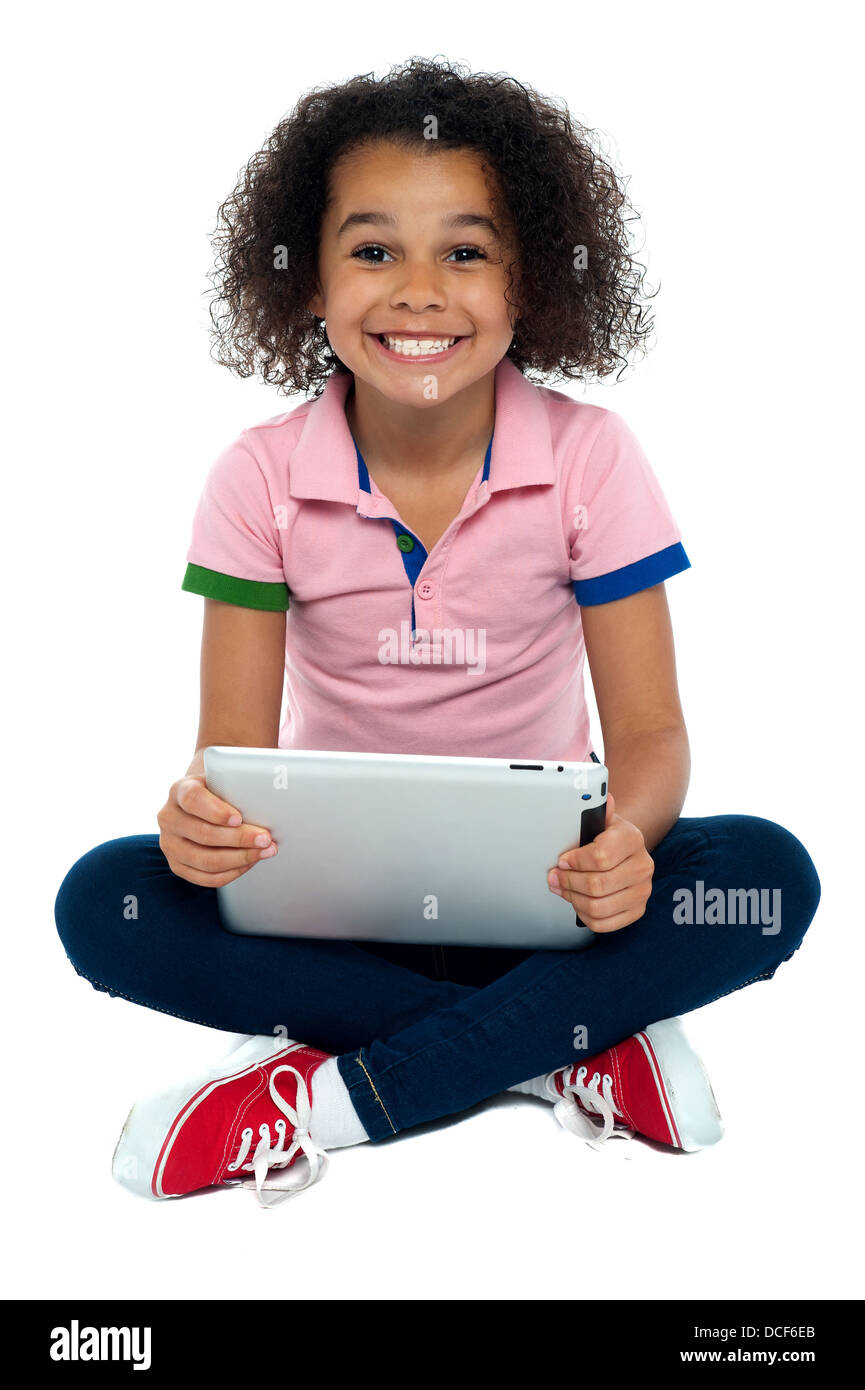 Cool girl kid sitting on the floor with wide grin on face holding ...