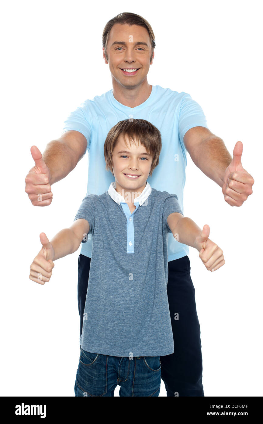 Handsome father and son showing thumbs up gesture to the camera ...