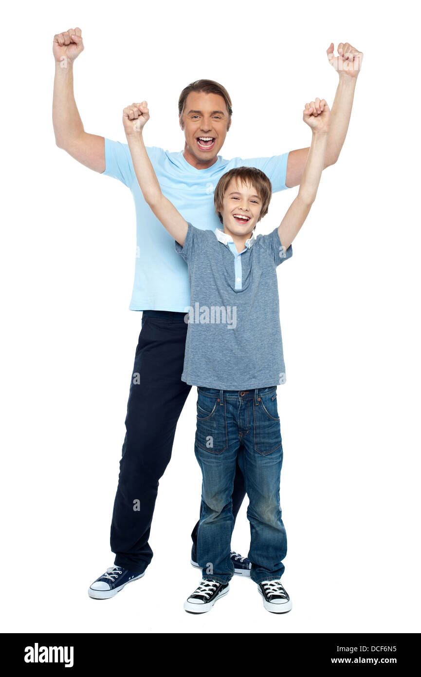 Father and son celebrating their success. Rejoicing with raised arms ...