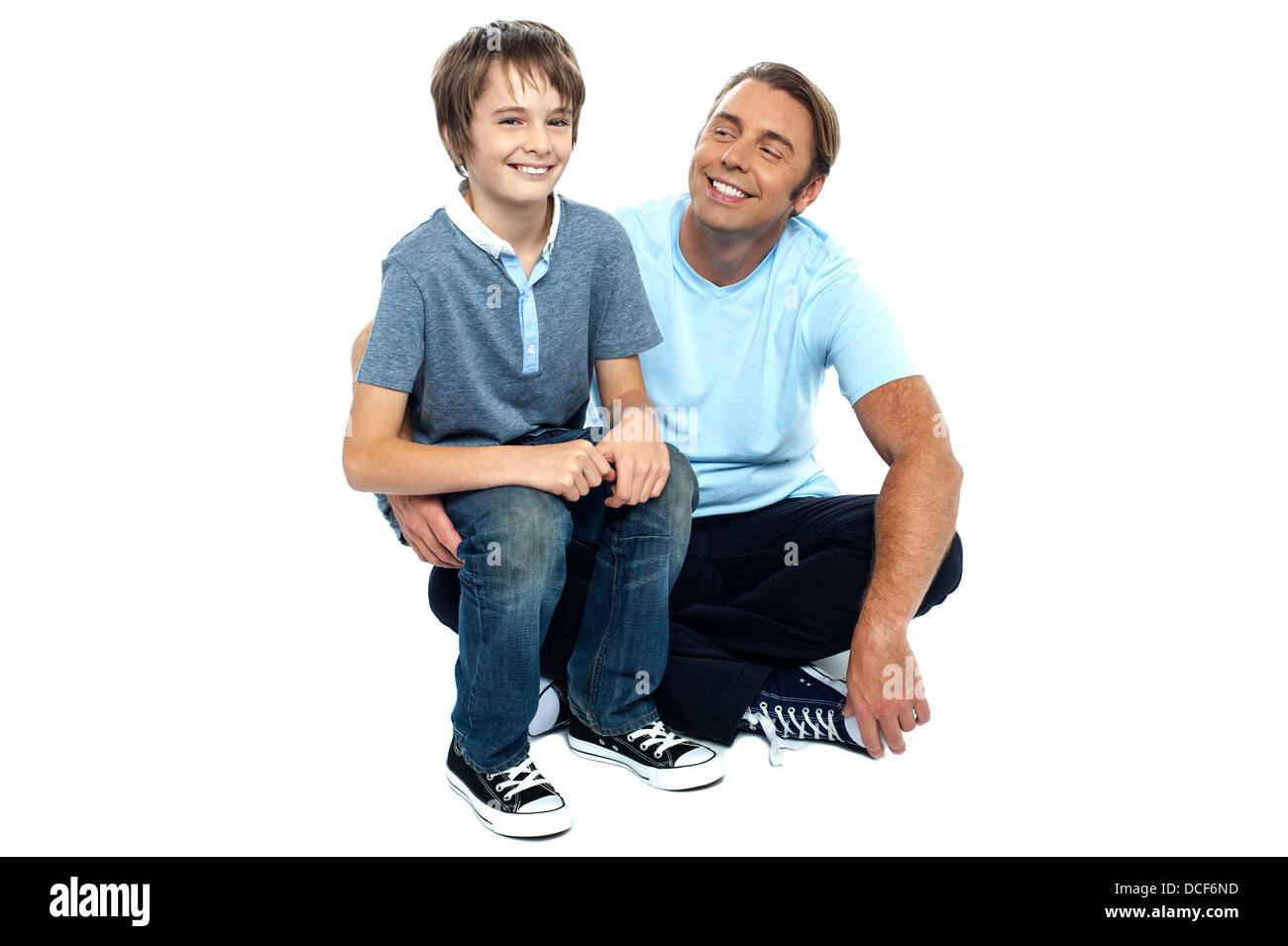 Affectionate father admiring his sweet son on his lap. Sitting on the ...