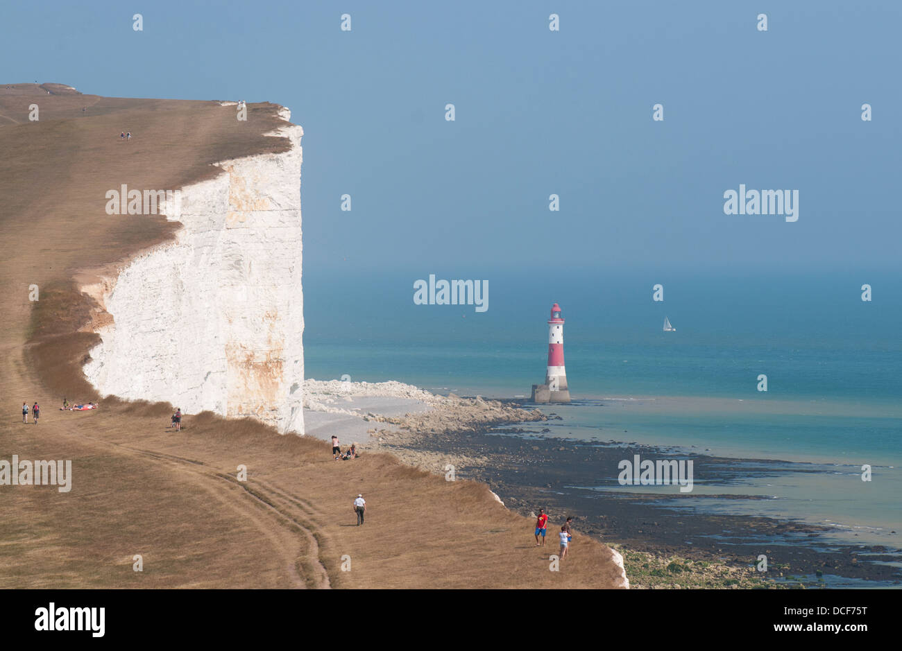 People walking along the cliff edge at Beachy Head in East Sussex ...