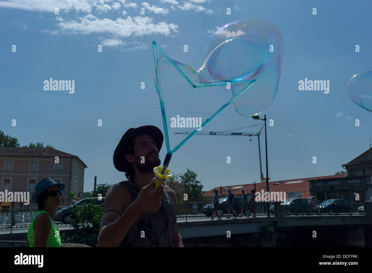 Man Making bubbles from soapy water with a machine Stock Photo - Alamy