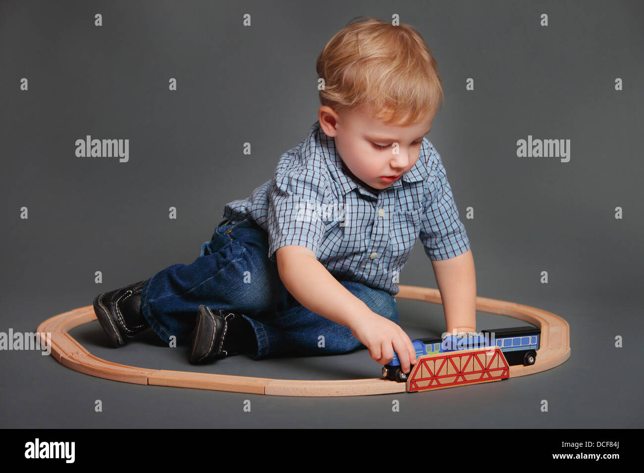 Boy Playing With Toy Train Stock Photo - Alamy