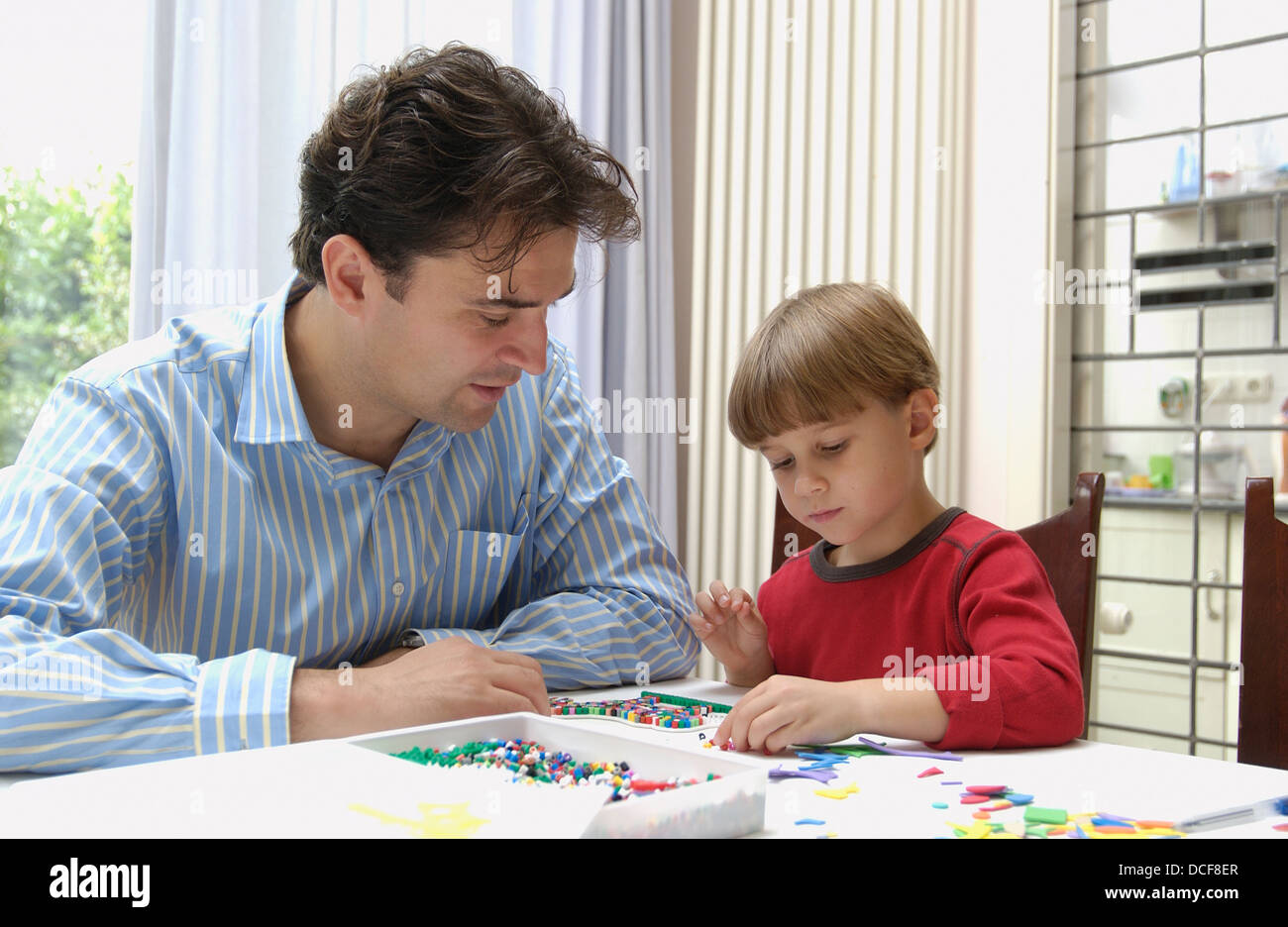 Father and son playing together Stock Photo - Alamy