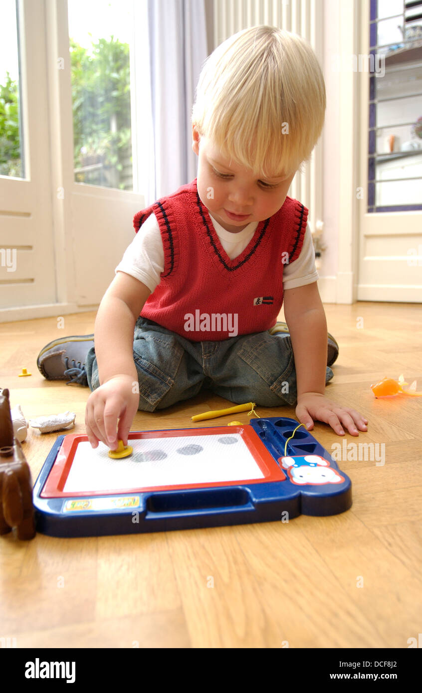 Little boy is playing on the floor Stock Photo - Alamy