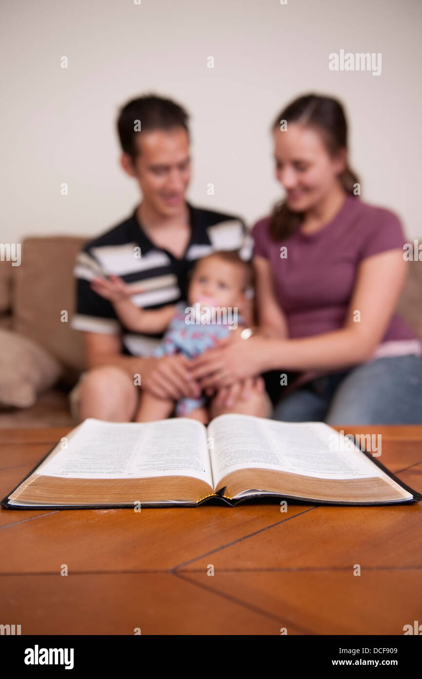 A Family With A Bible On The Coffee Table Stock Photo - Alamy